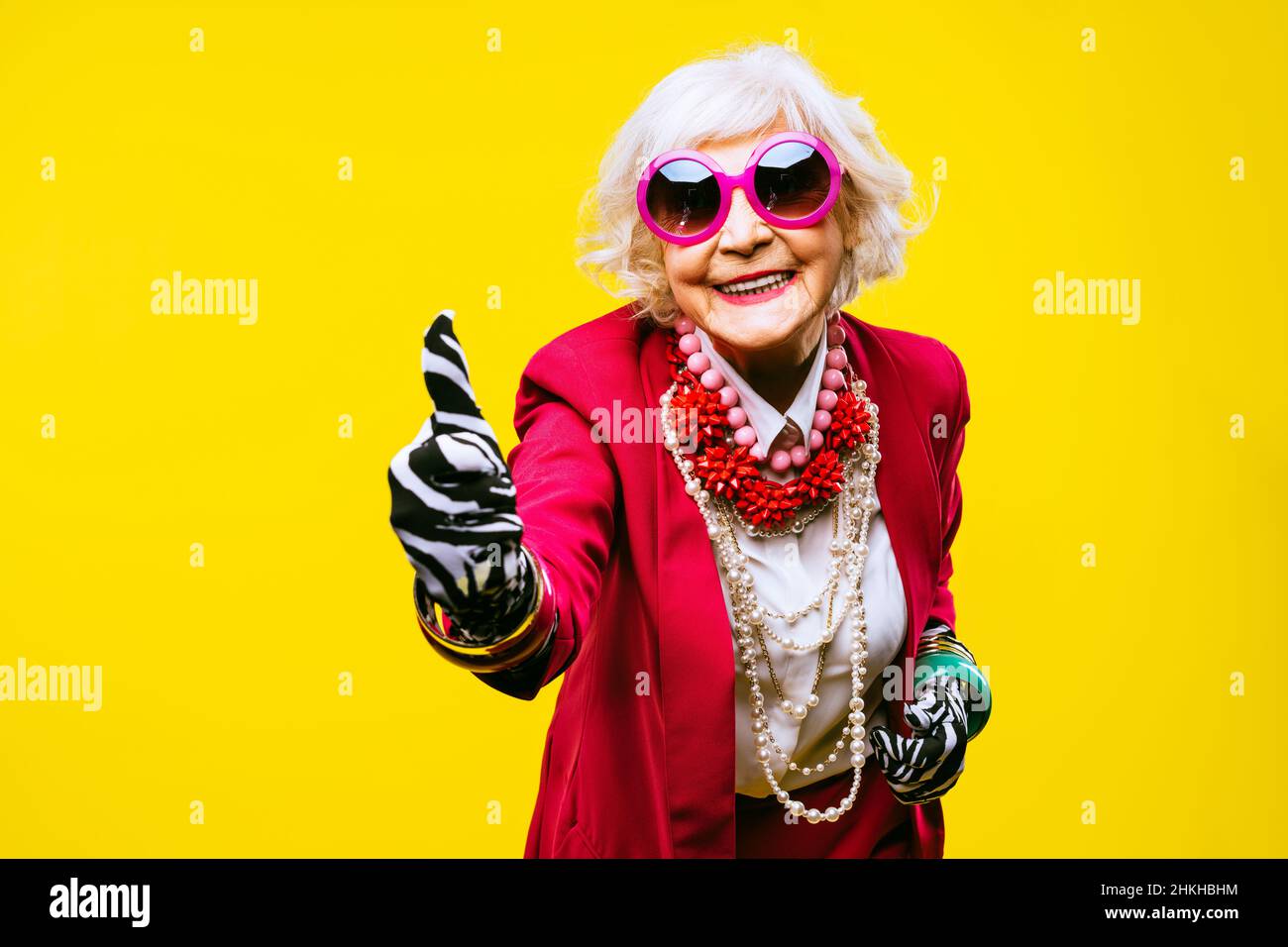 Happy and funny cool old lady with fashionable clothes portrait on ...