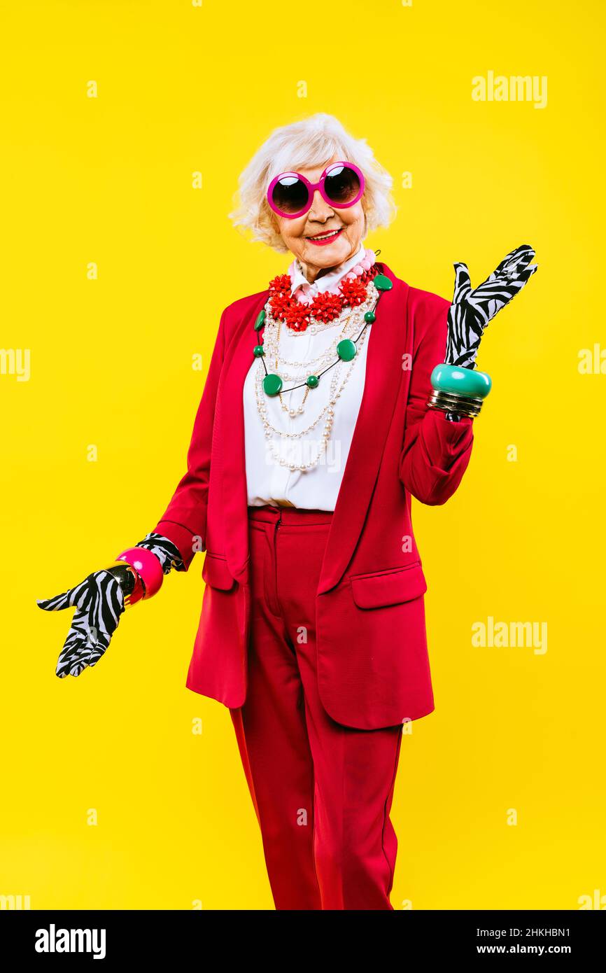 Happy and funny cool old lady with fashionable clothes portrait on ...