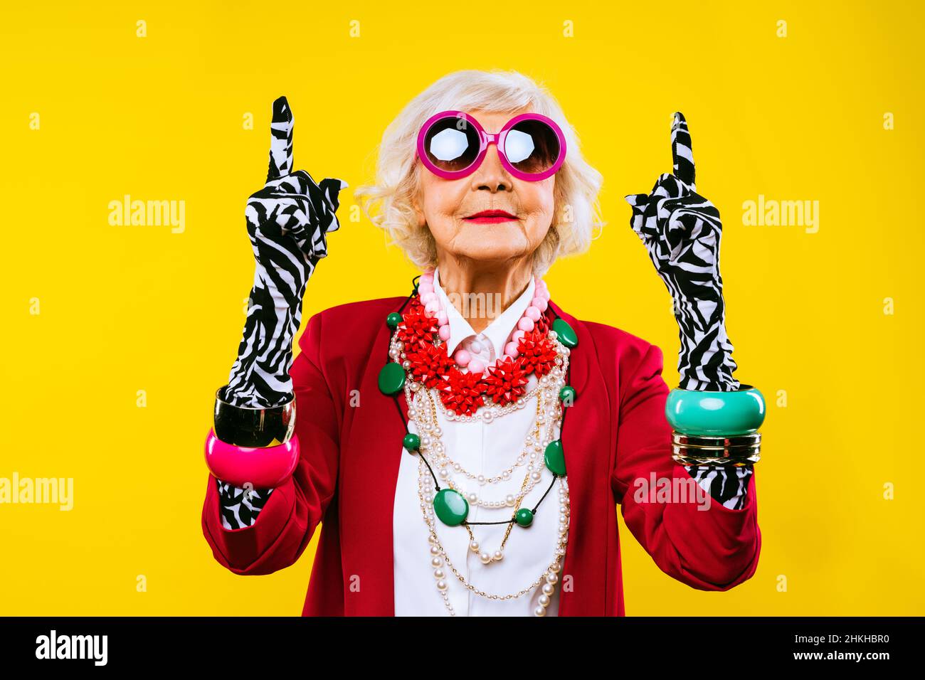 Happy and funny cool old lady with fashionable clothes portrait on ...