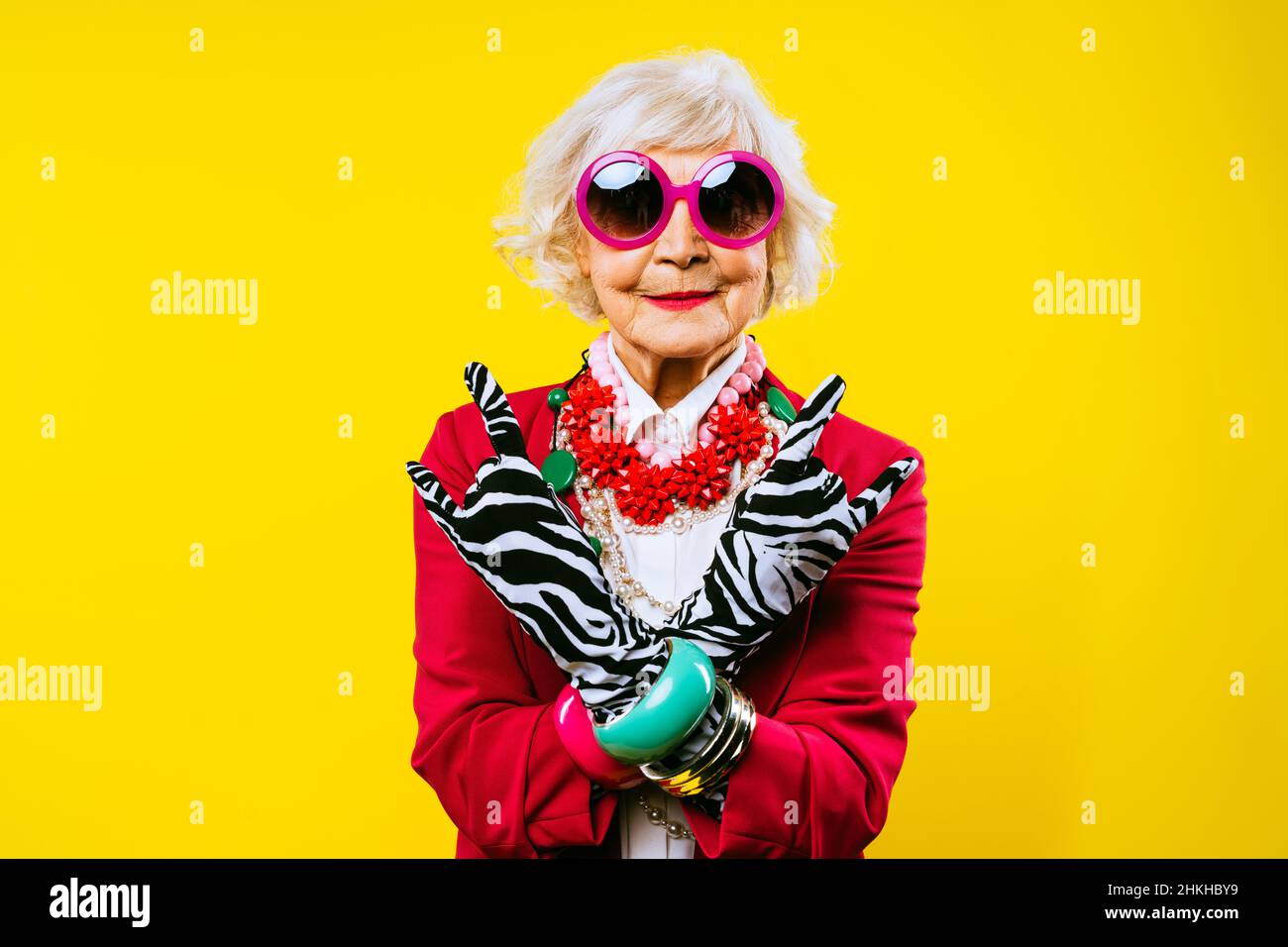 Happy and funny cool old lady with fashionable clothes portrait on ...