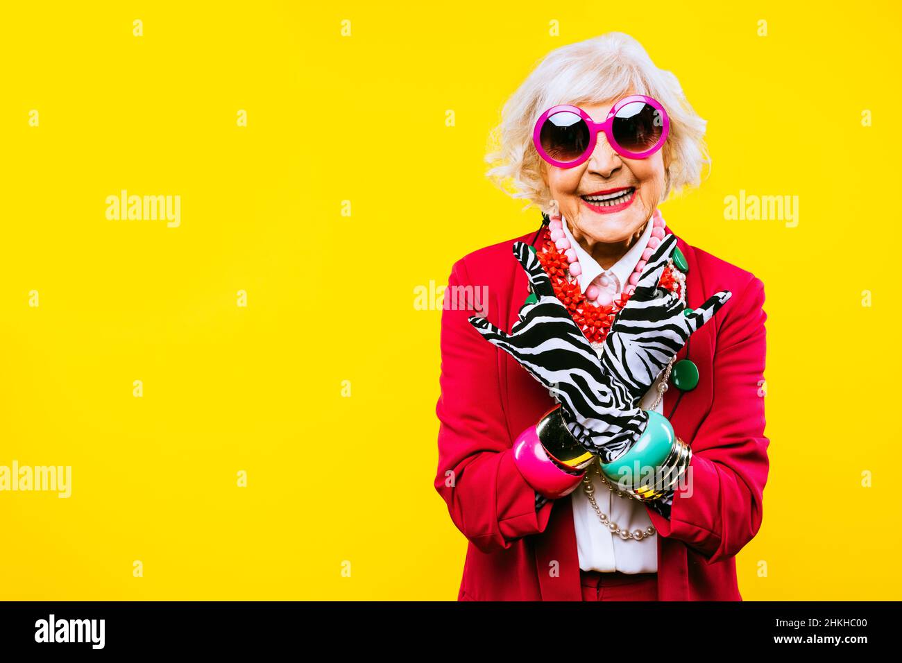 Happy and funny cool old lady with fashionable clothes portrait on ...