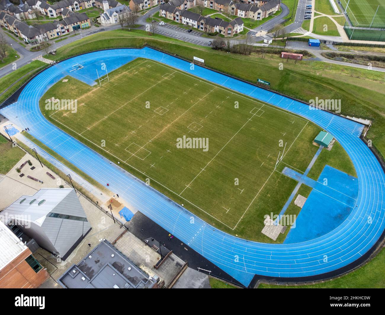 Rugby stadium, green grass, blue running track around the stadium Stock ...