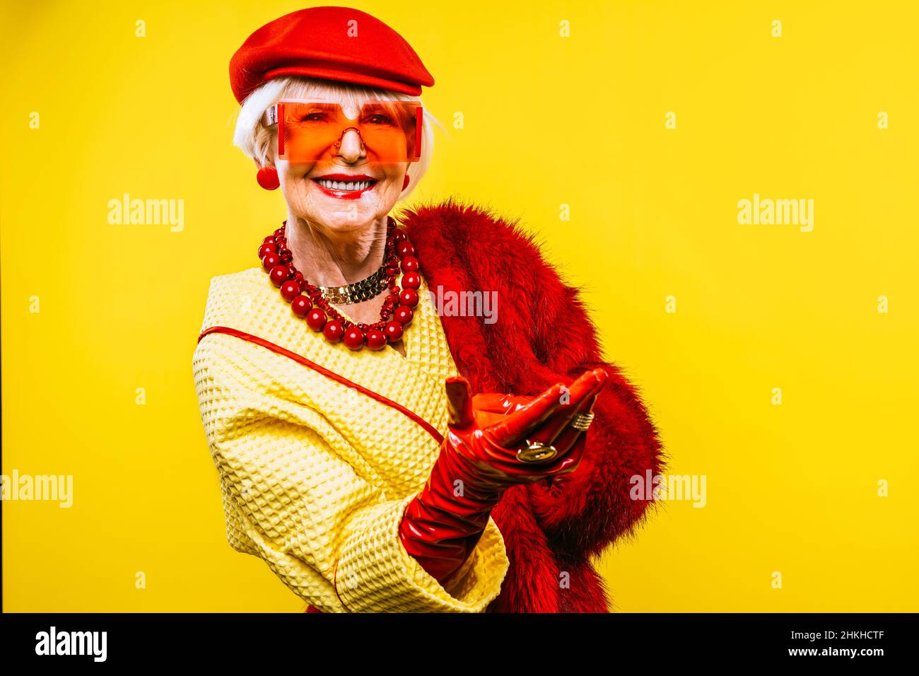 Happy and funny cool old lady with fashionable clothes portrait on ...