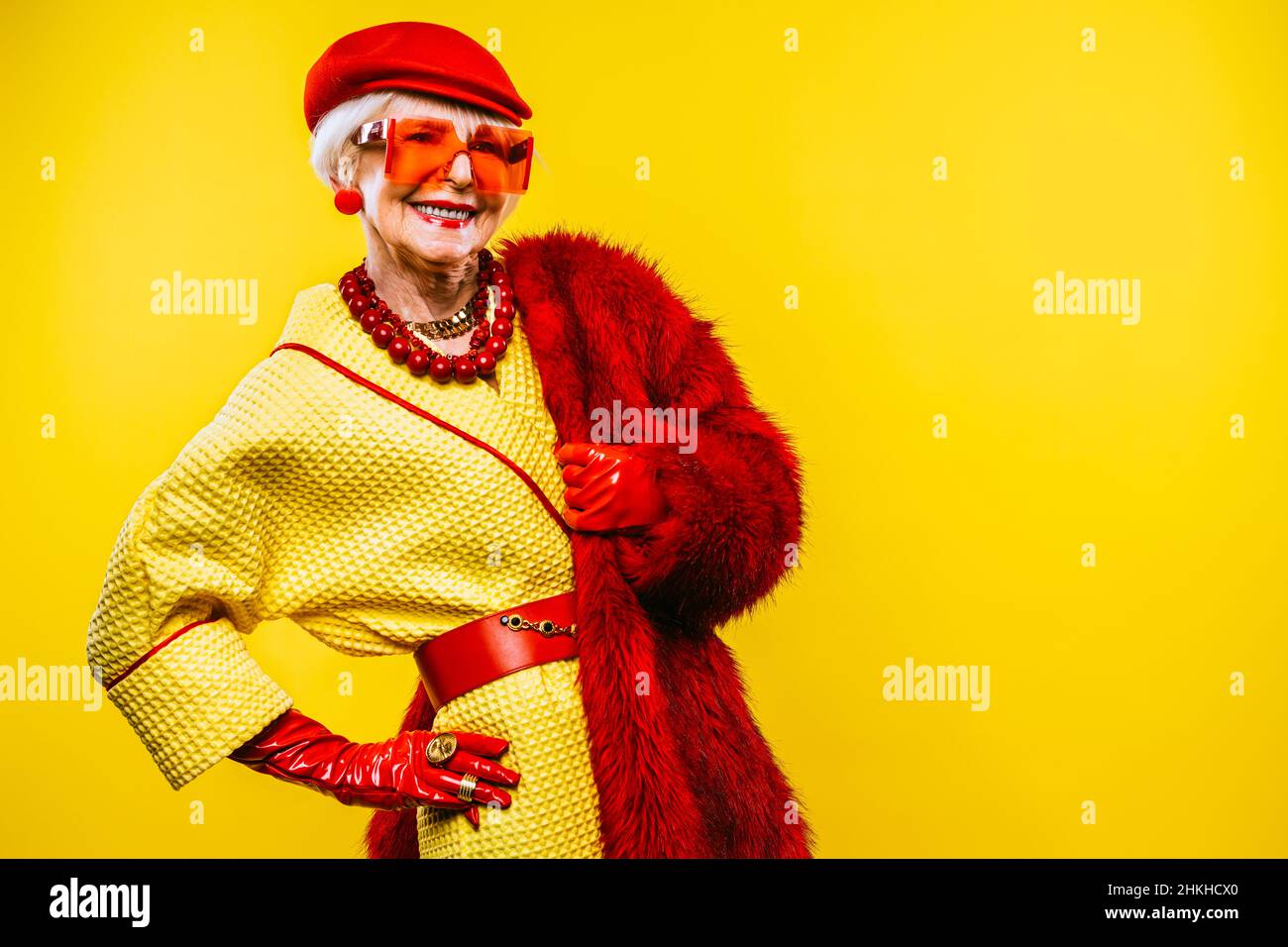 Happy and funny cool old lady with fashionable clothes portrait on ...