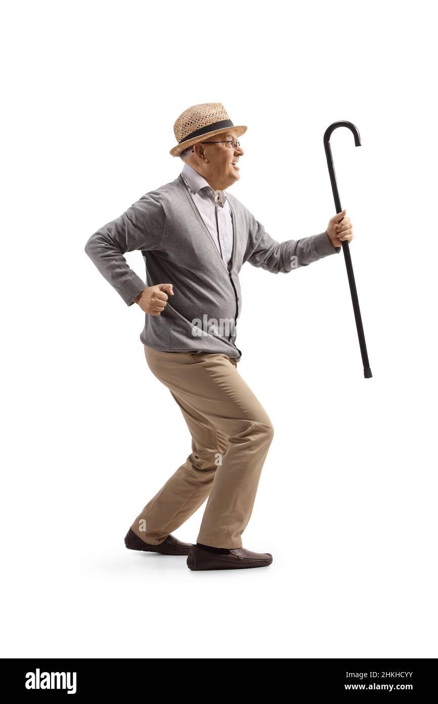 Happy elderly man with a walking cane dancing isolated on white ...
