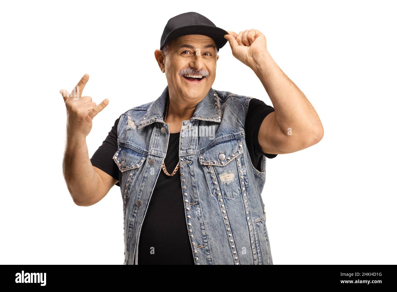 Smiling trendy mature man holding his cap and gesturing a rock and roll ...