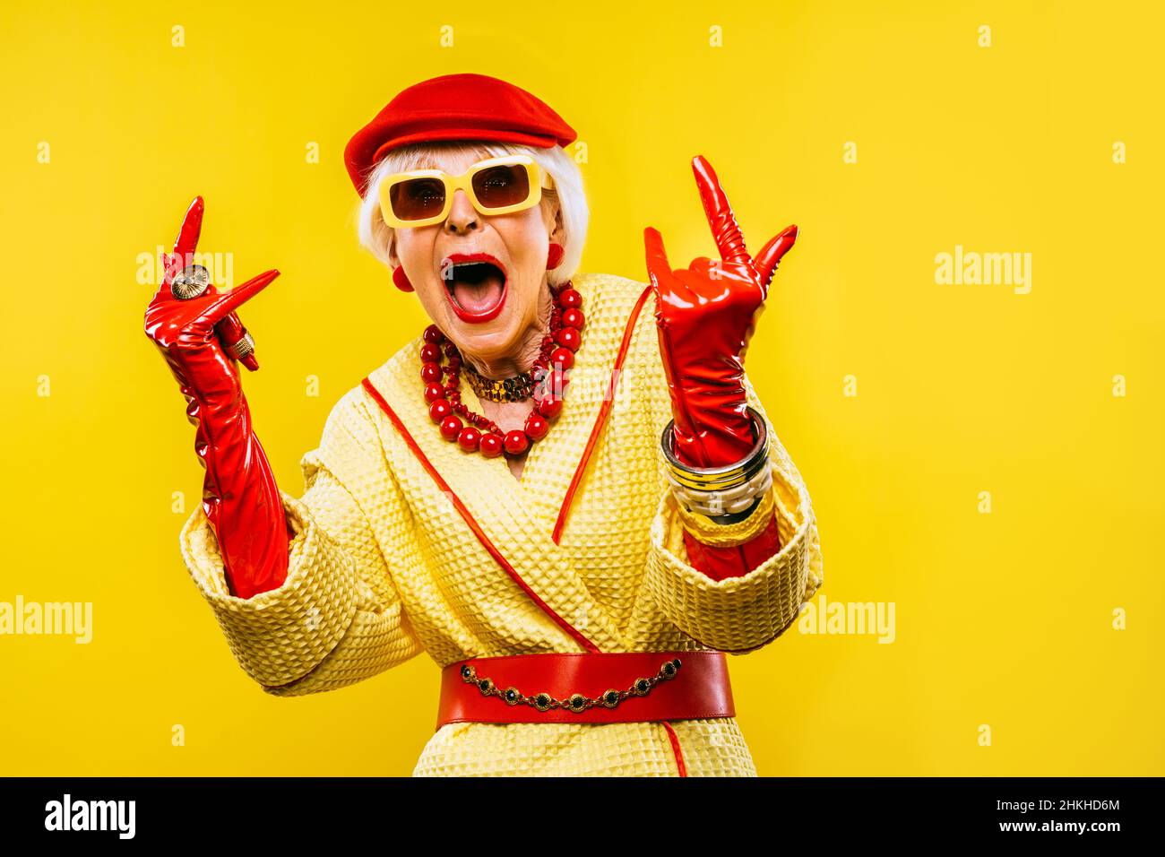 Happy and funny cool old lady with fashionable clothes portrait on ...