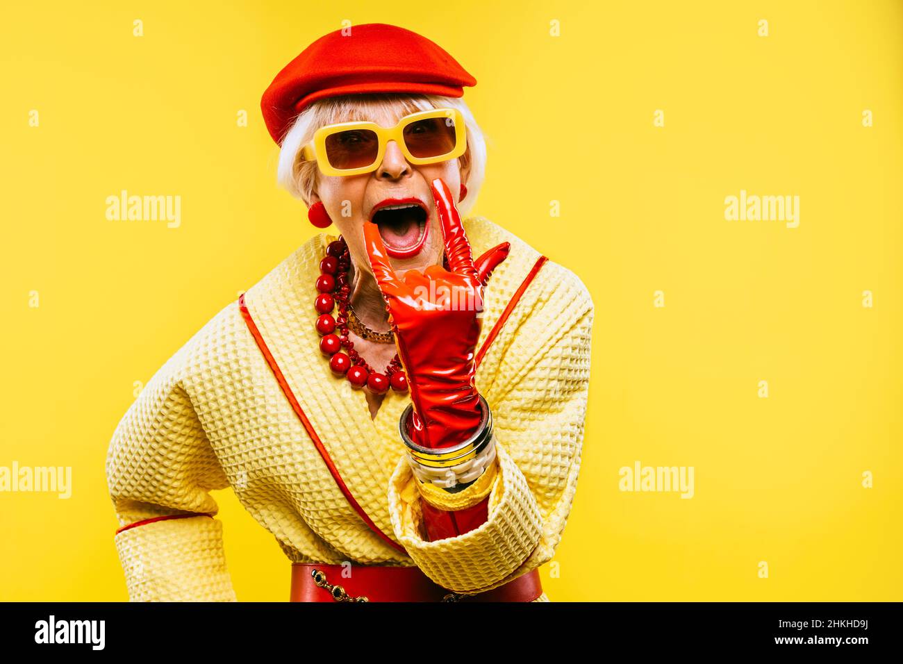 Happy and funny cool old lady with fashionable clothes portrait on ...