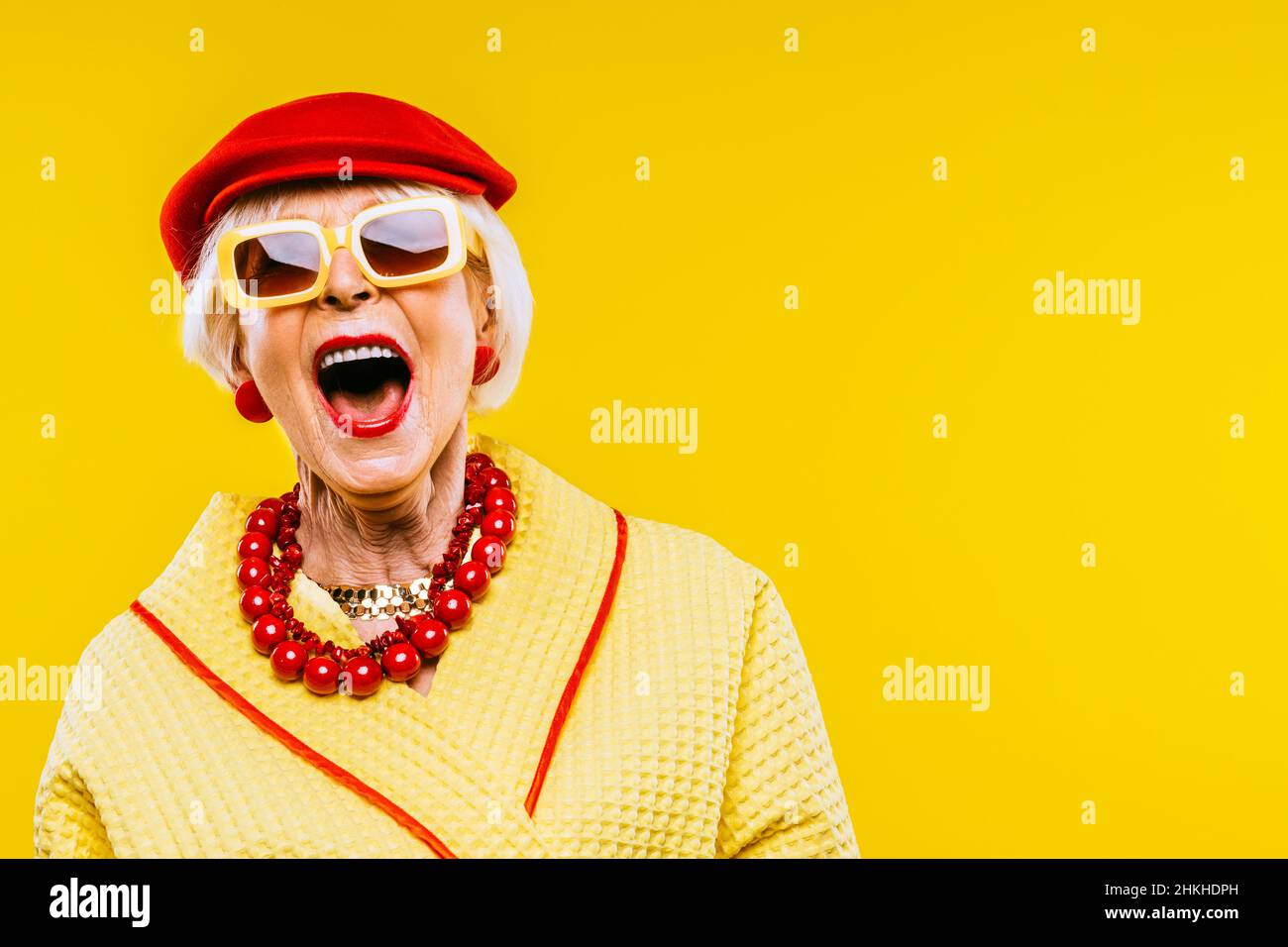 Happy and funny cool old lady with fashionable clothes portrait on ...