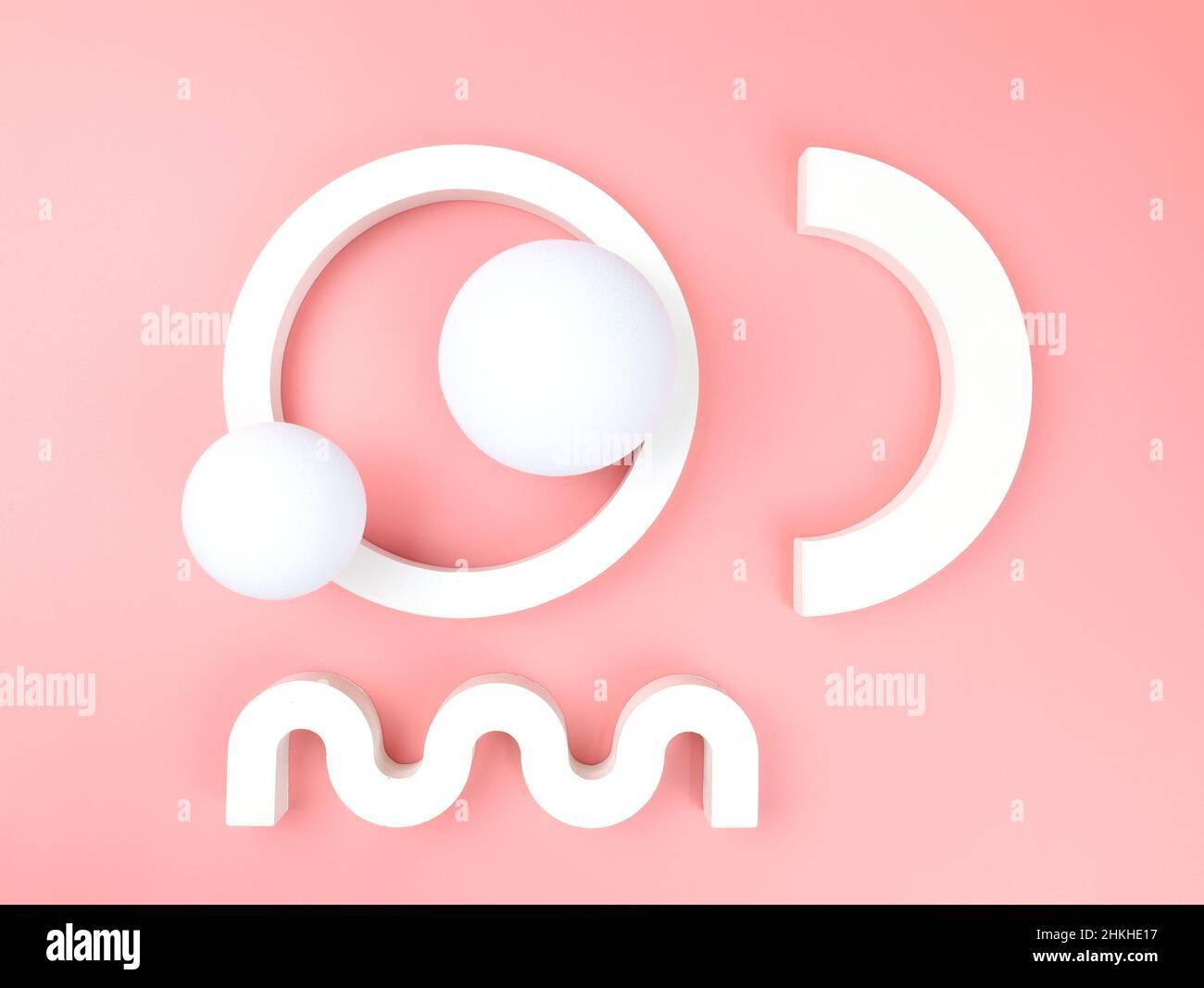 Gypsum figures of different shapes on a pink background top view ...