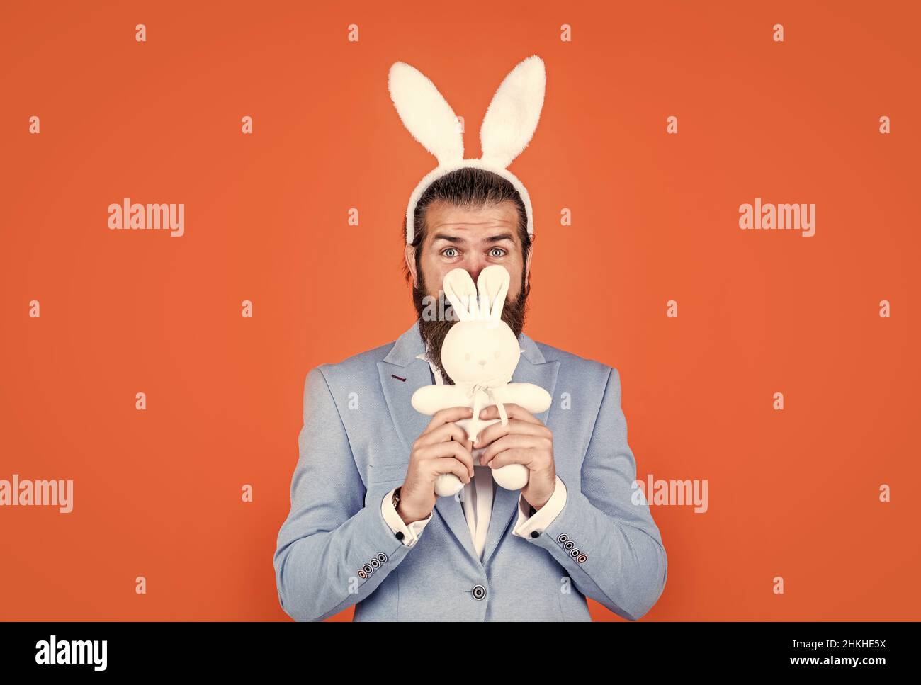 last preparations. brutal man having fun. mature male wear rabbit ears. easter bunny man. happy ...