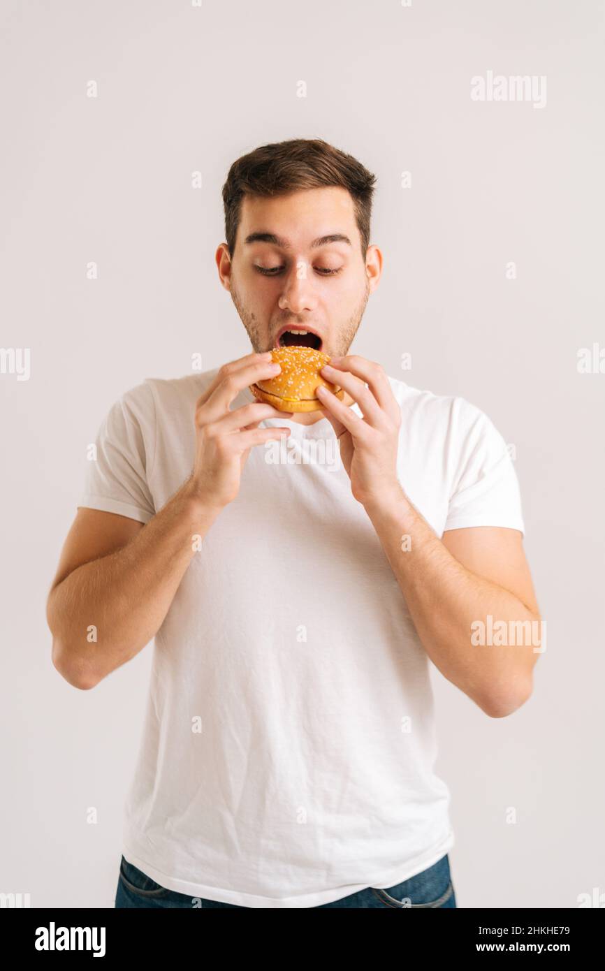 Man eating sandwich standing hi-res stock photography and images - Alamy