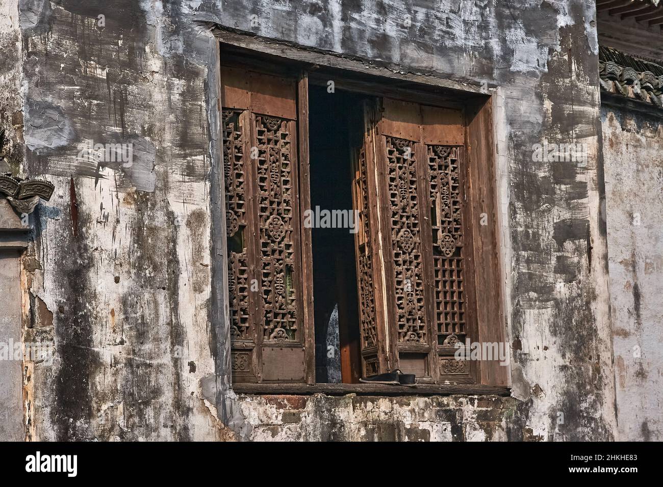 Exquisite traditional wood carving on window shutters in an old Chinese ...