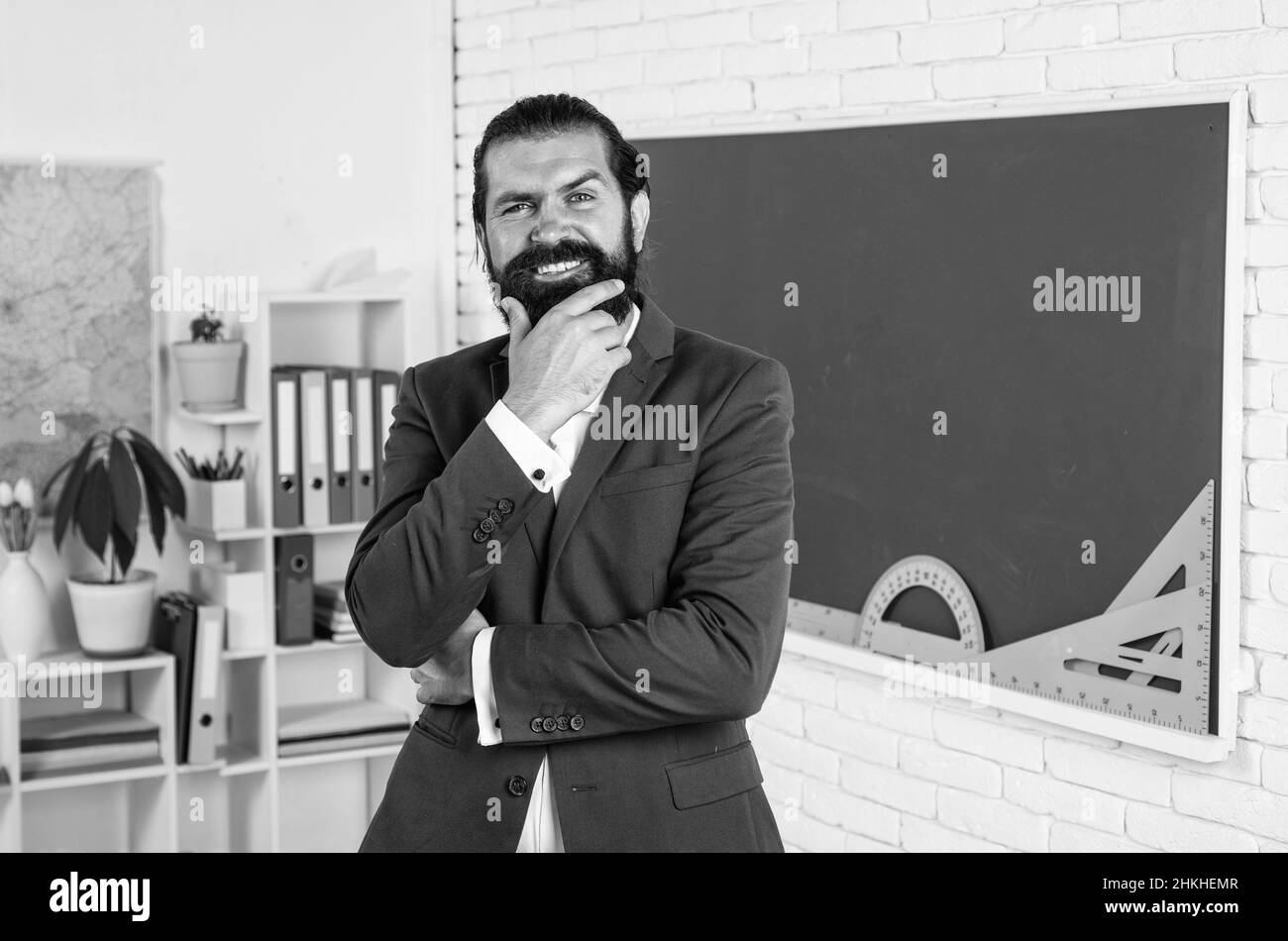 learning the subject. happy man with beard wearing formal suit. process ...