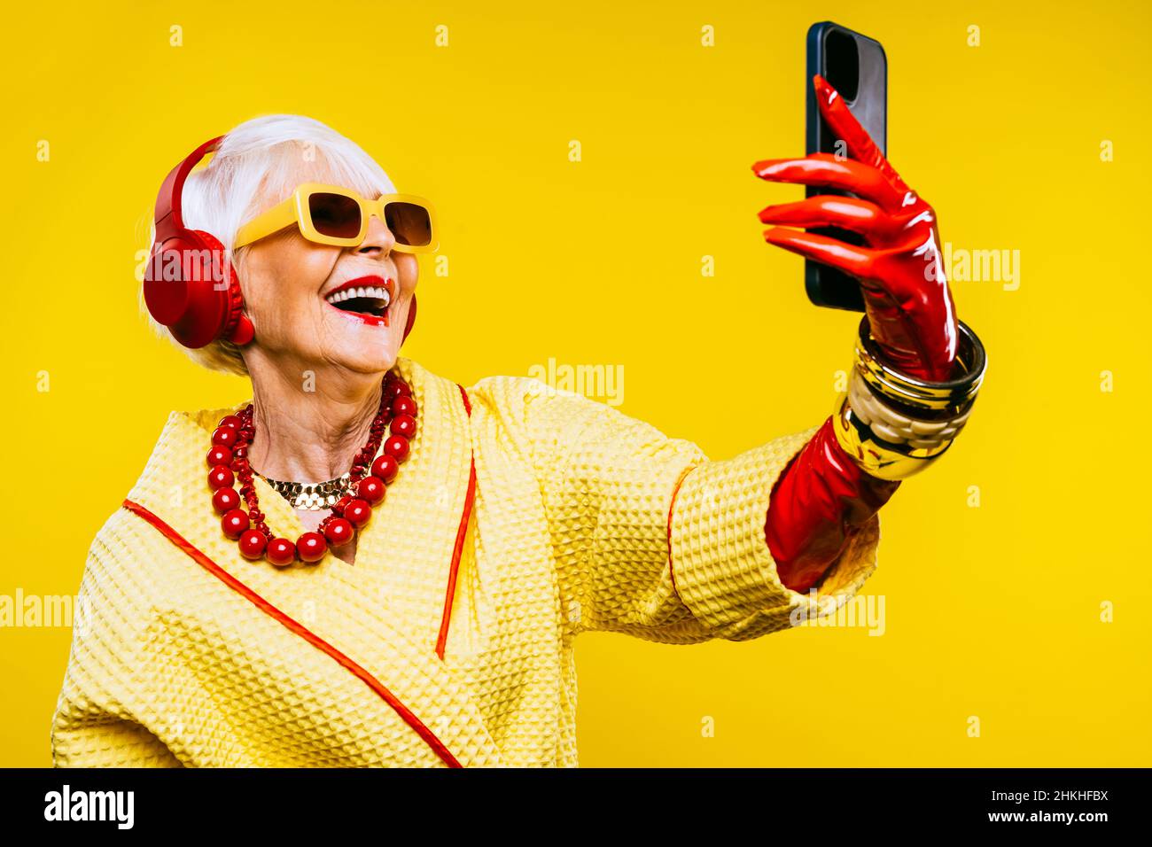 Happy and funny cool old lady with fashionable clothes portrait on ...