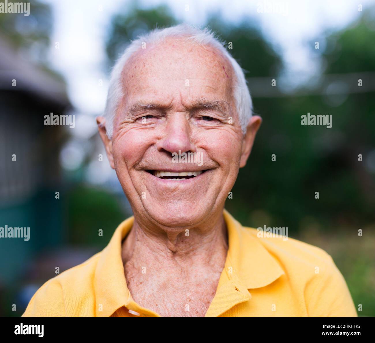 Portrait of an elderly man 70 years old in his garden on summer sunny ...