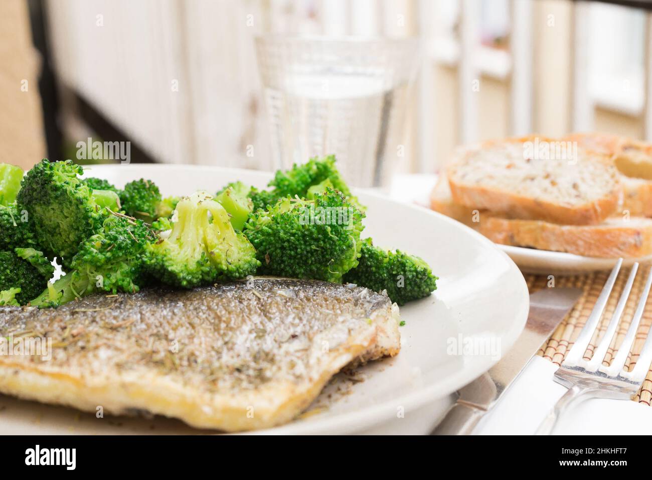 dish of fried dorado fish fillet with boiled broccoli Stock Photo - Alamy