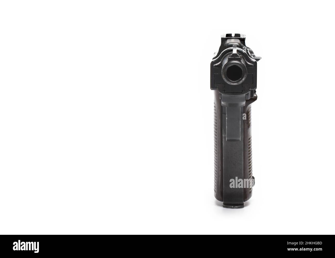 Close up of black semiautomatic pistol with barrel pointing right at ...