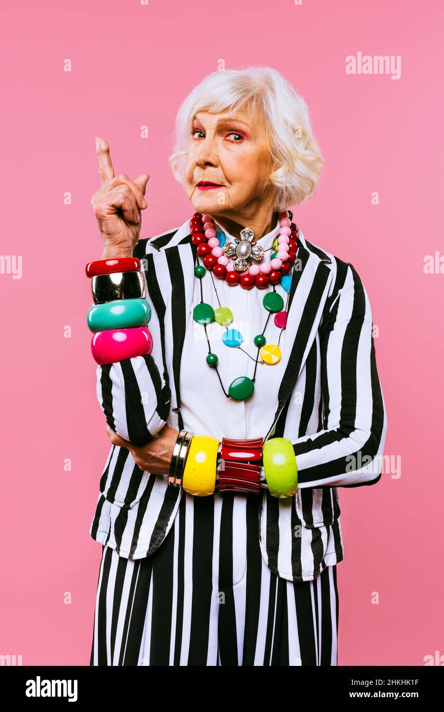 Happy and funny cool old lady with fashionable clothes portrait on ...