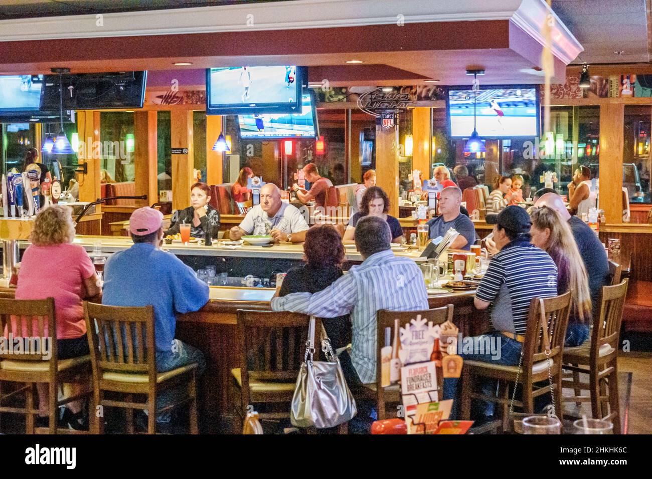 Bar men women couples customers big screen tv flat panel hi-res stock ...