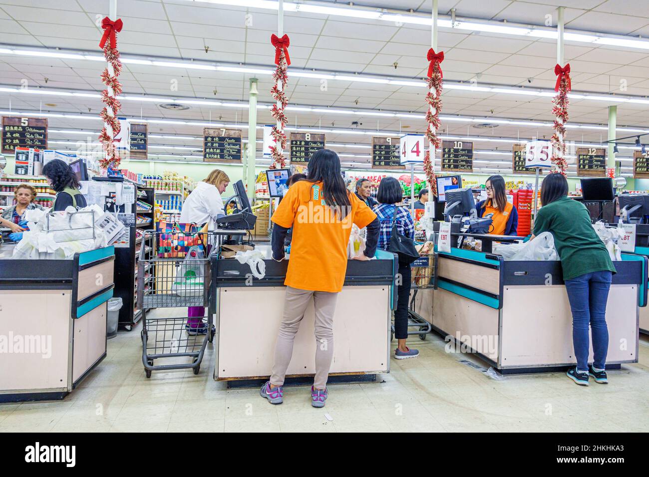 Grocery food store supermarket cashier asian women baggers hi-res stock ...