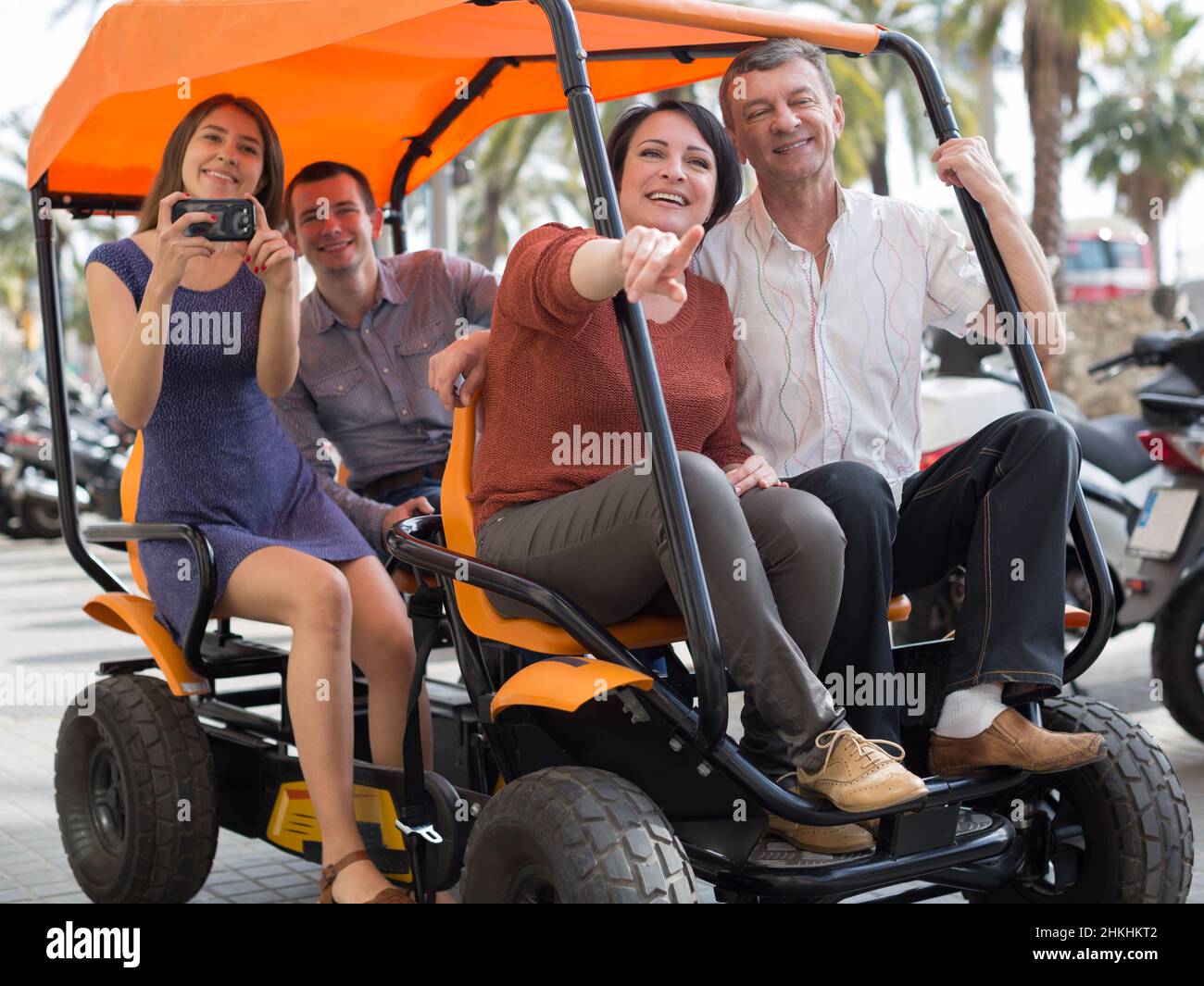 family of tourists enjoy a walk on the bike carriage Stock Photo - Alamy