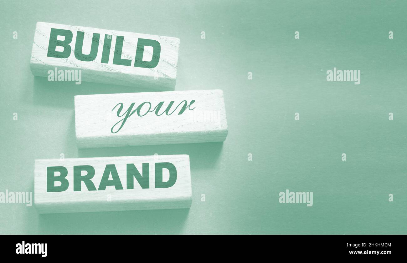 Phrase BUILD YOUR BRAND written on wooden blocks. With vintage styled ...