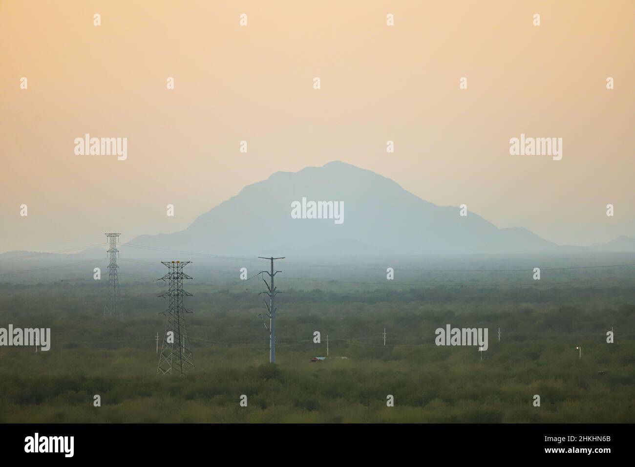 Fog and green landscape between the high tension or electric current ...