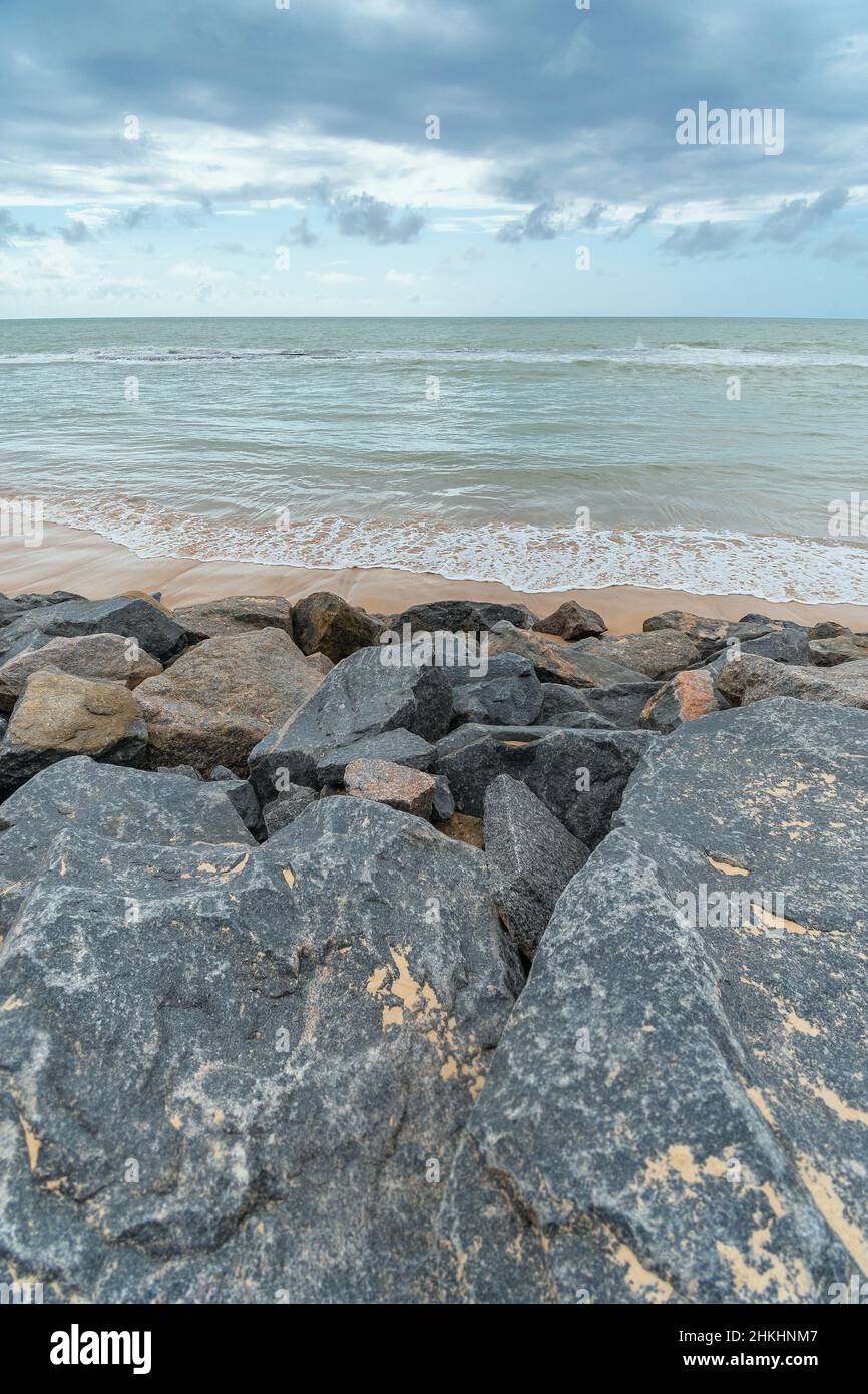 Landscape of a path of rocks in front of the beach, sand strip the ...