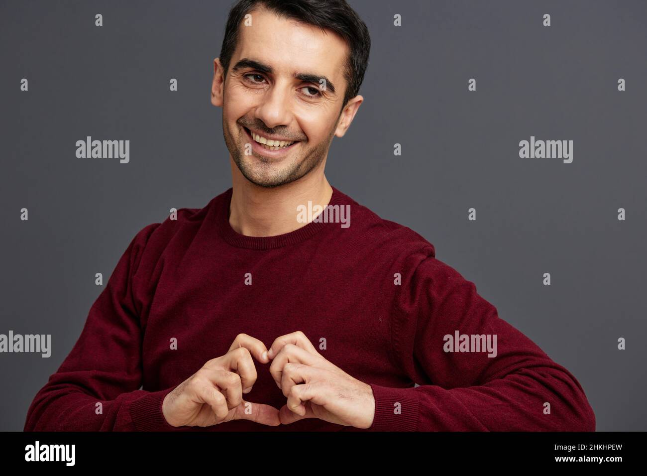successful man posing smile gesture hands red sweater Gray background ...