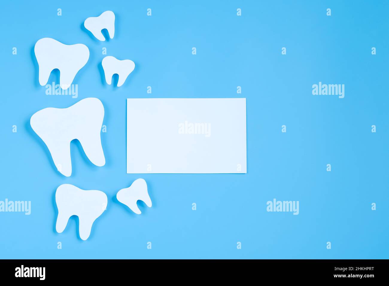 Paper cut mockup of tooth on blue background. Dental care concept ...