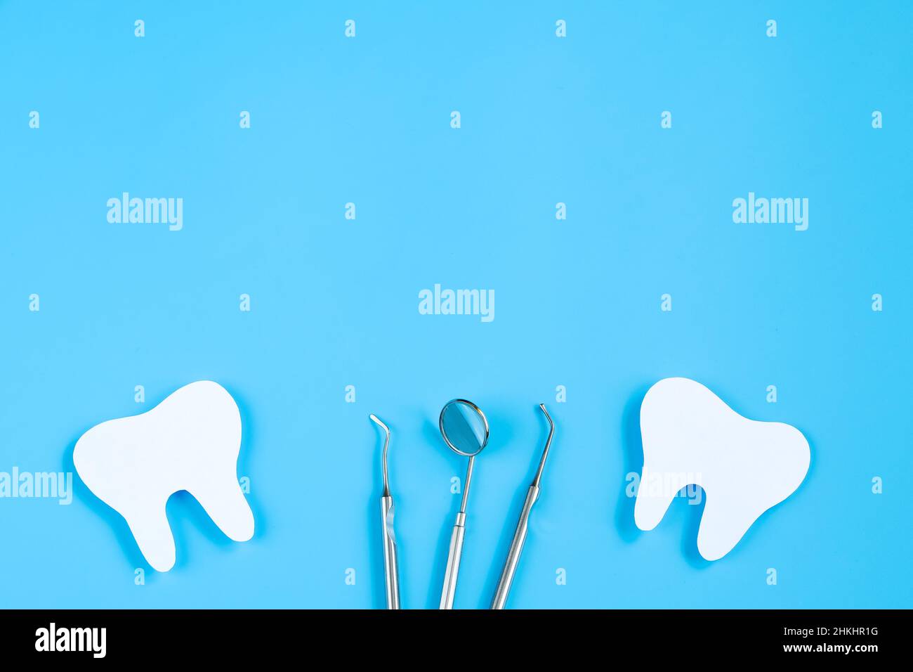 Happy International Dentist Day. Paper cut mockup of tooth and dental tool on blue background ...