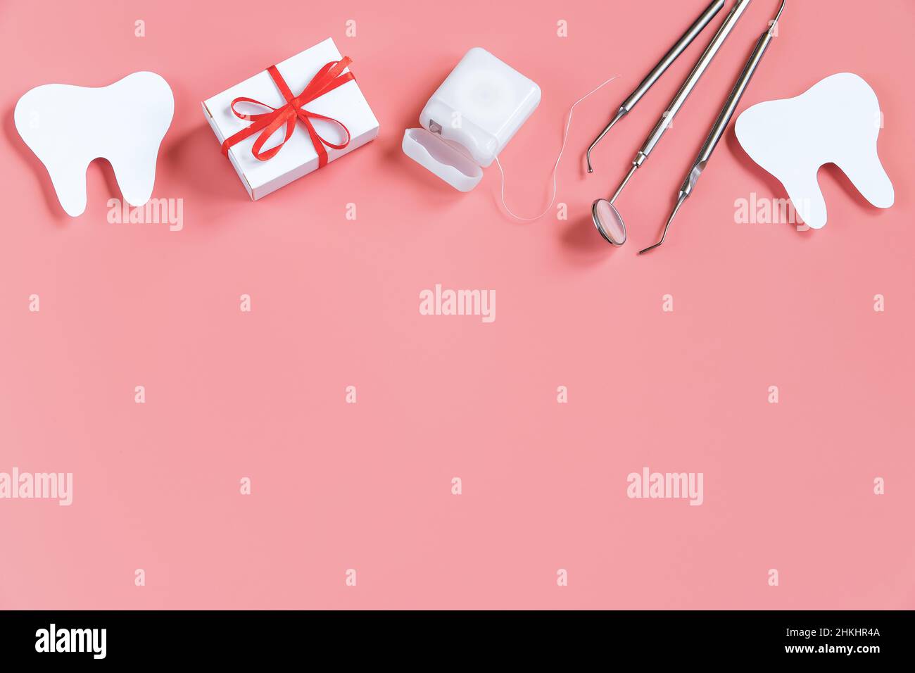 Dental care concept. Dental tools on pink background. Happy dentist day. Paper cut mockup of ...