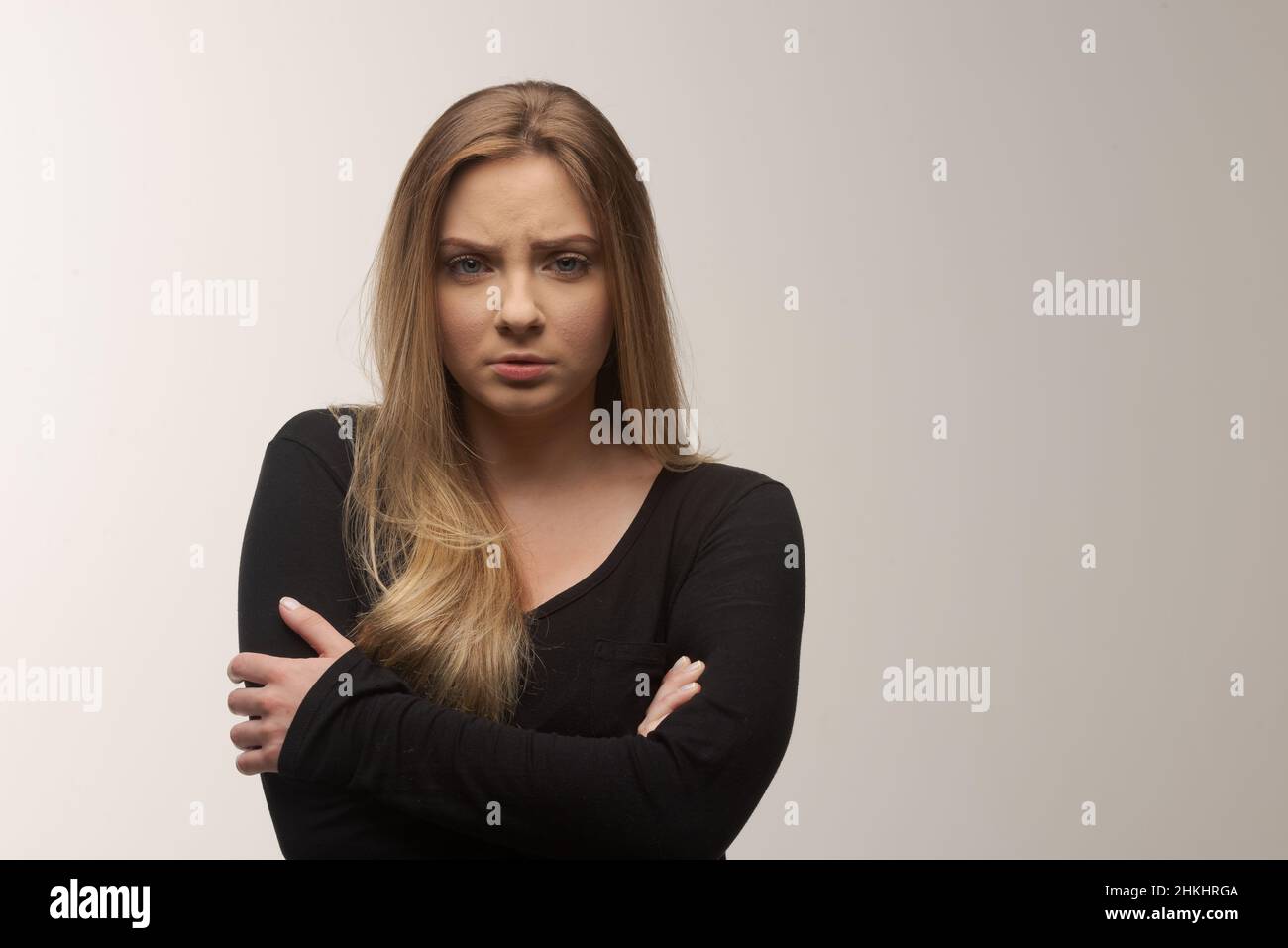 Angry sad young woman portrait in studio white background Stock Photo ...