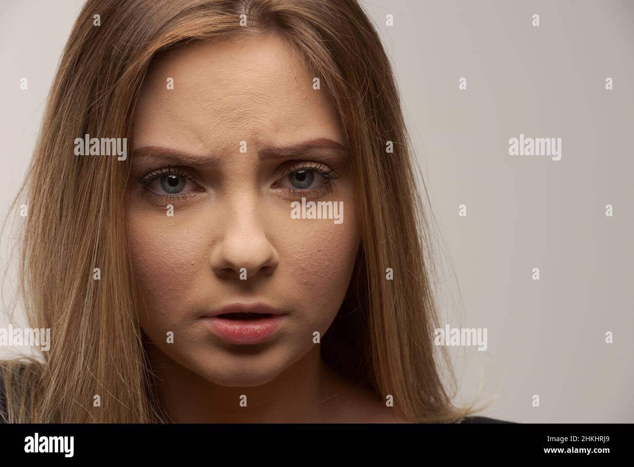 Angry sad young woman portrait in studio white background Stock Photo ...