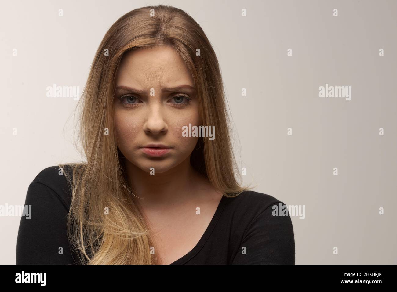 Angry sad young woman portrait in studio white background Stock Photo ...