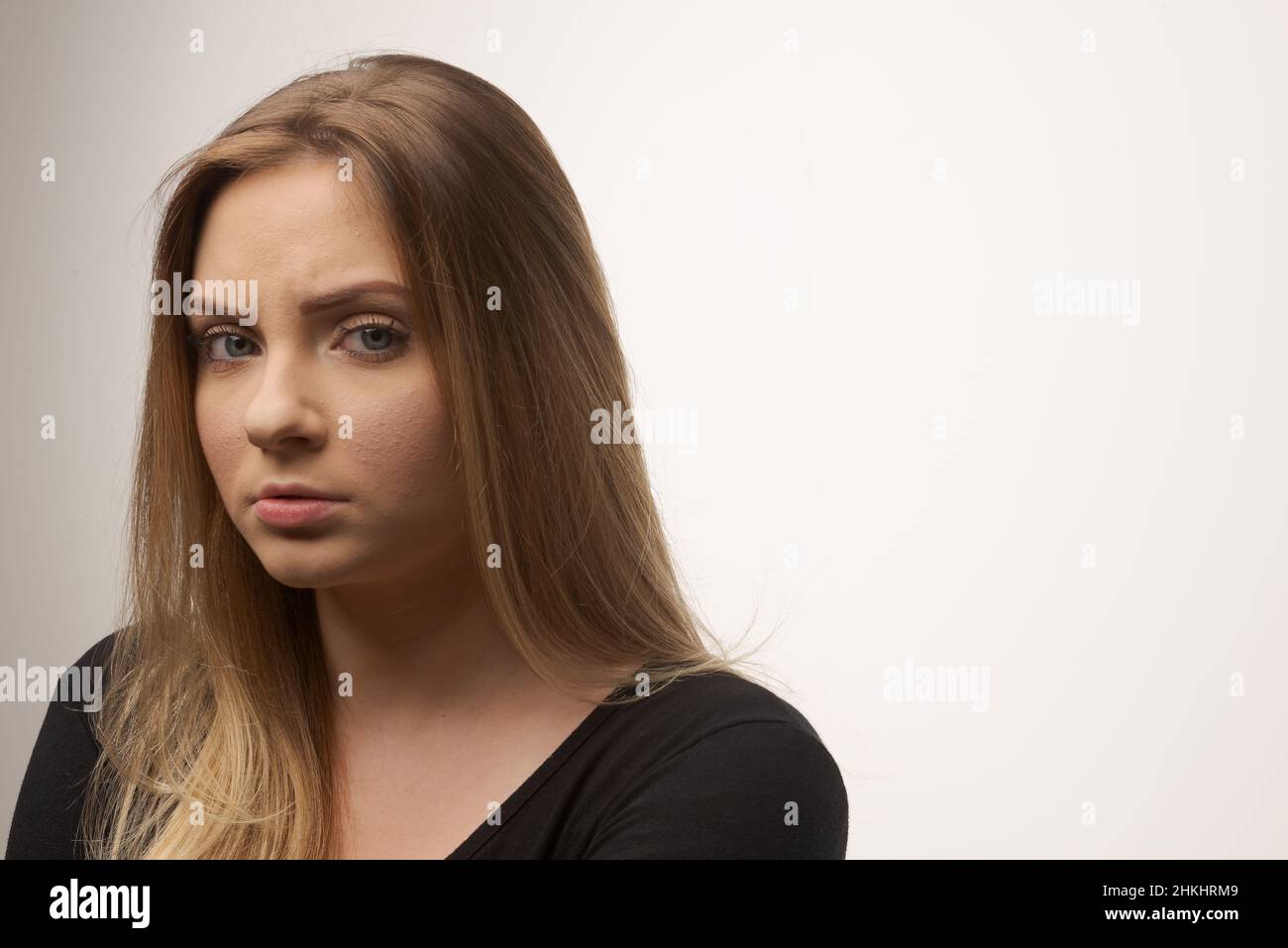 Angry sad young woman portrait in studio white background Stock Photo ...