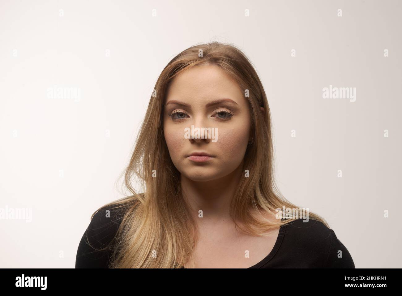 Angry sad young woman portrait in studio white background Stock Photo ...