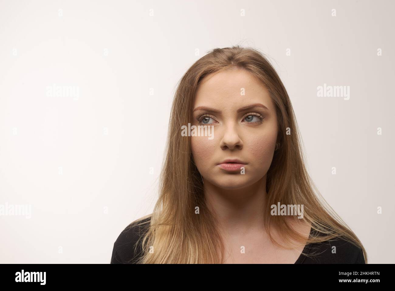 Angry sad young woman portrait in studio white background Stock Photo ...