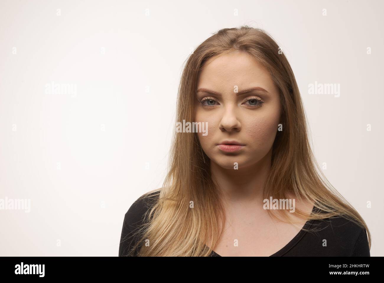 Angry sad young woman portrait in studio white background Stock Photo ...
