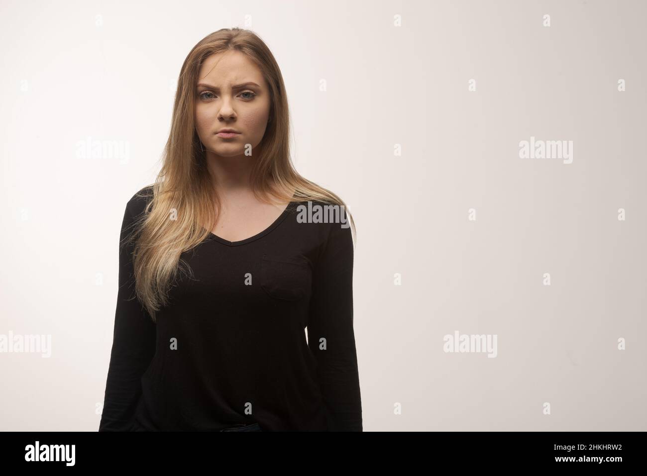 Angry sad young woman portrait in studio white background Stock Photo ...