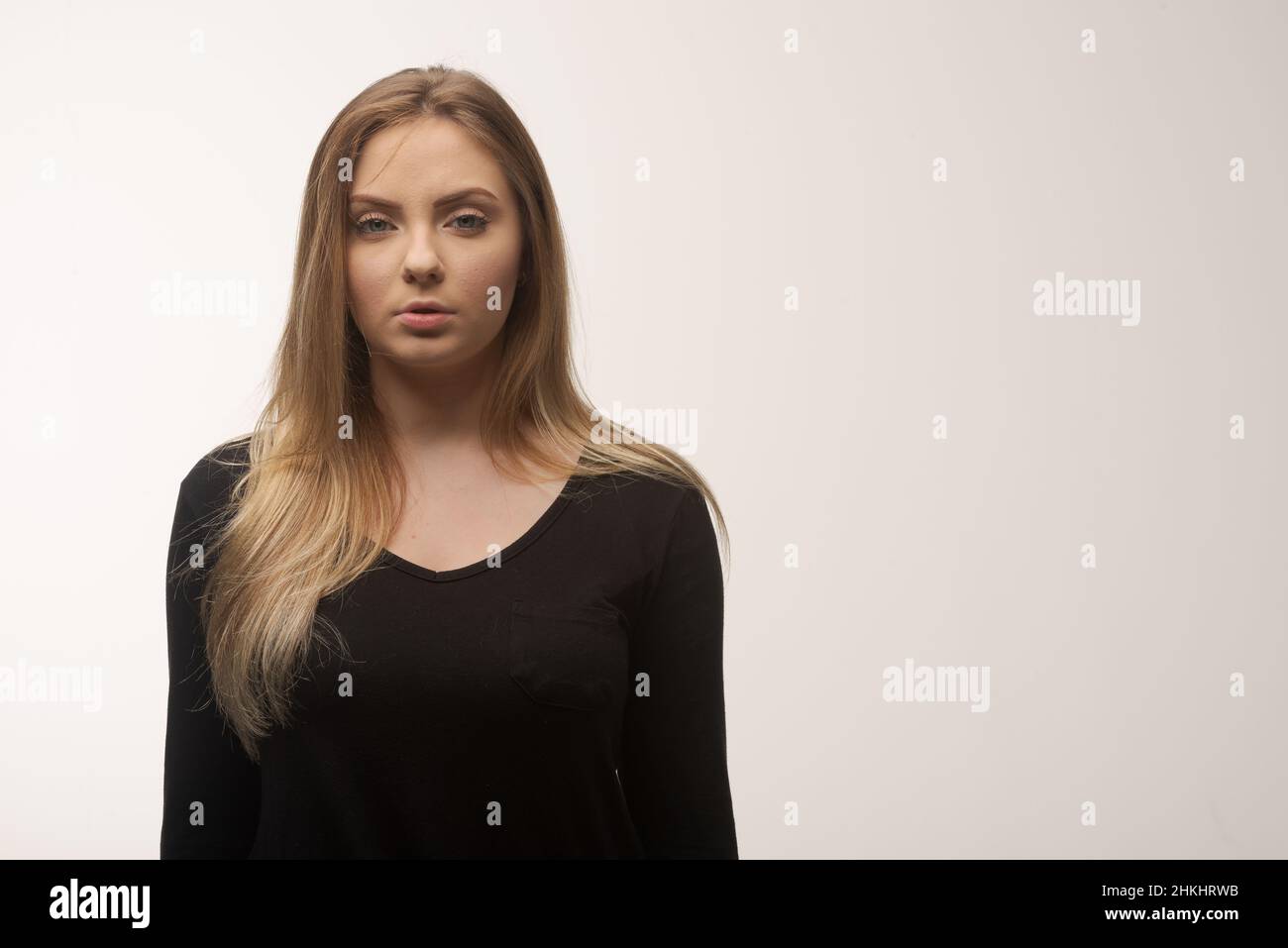 Angry sad young woman portrait in studio white background Stock Photo ...
