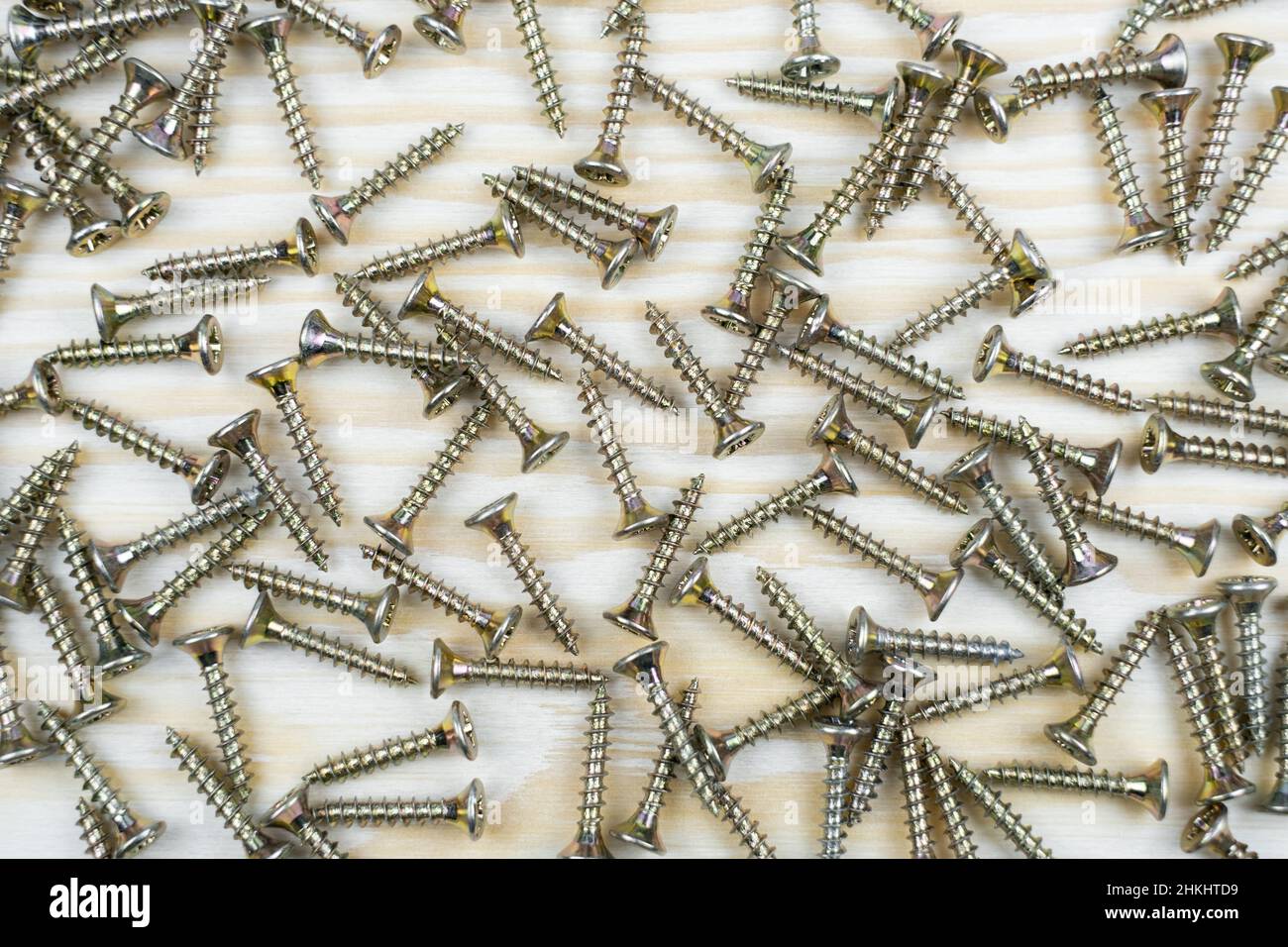 A pile of screw scattered on a wood bg. Close up, top view Stock Photo ...