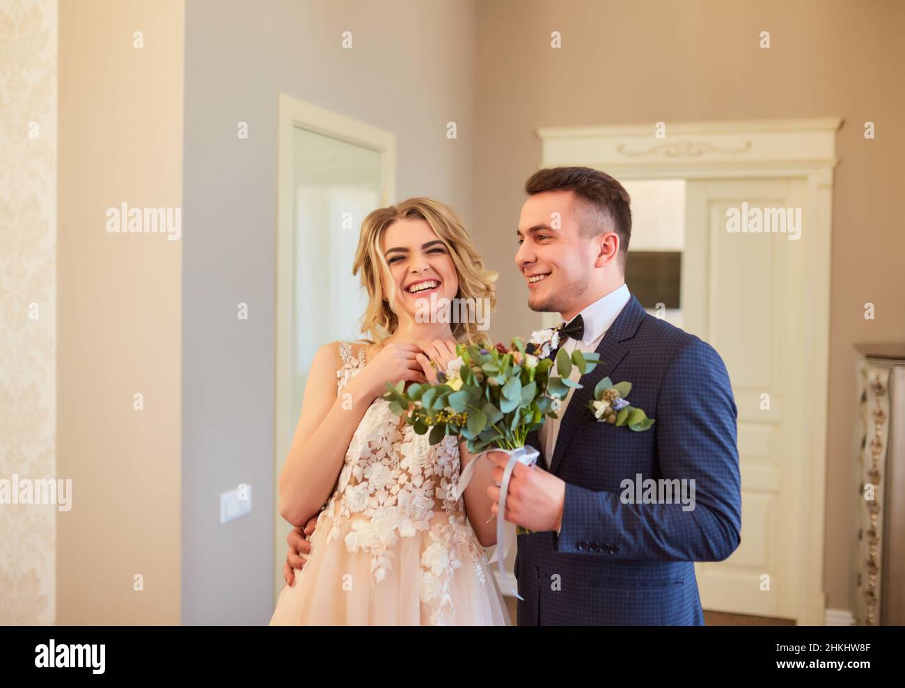 Beautiful couple of young bride and groom in luxurious outfits ...