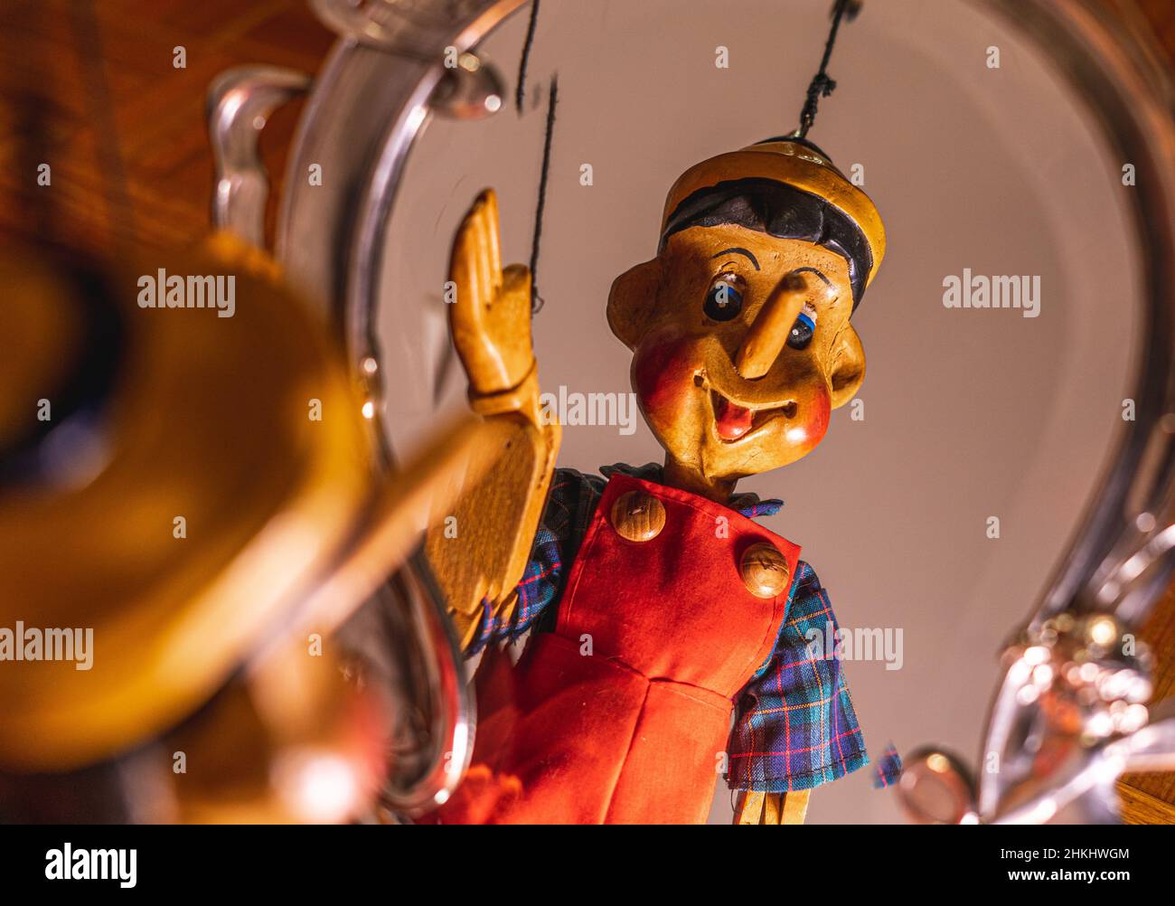 Pinocchio puppet brawled in a mirror waving Stock Photo - Alamy