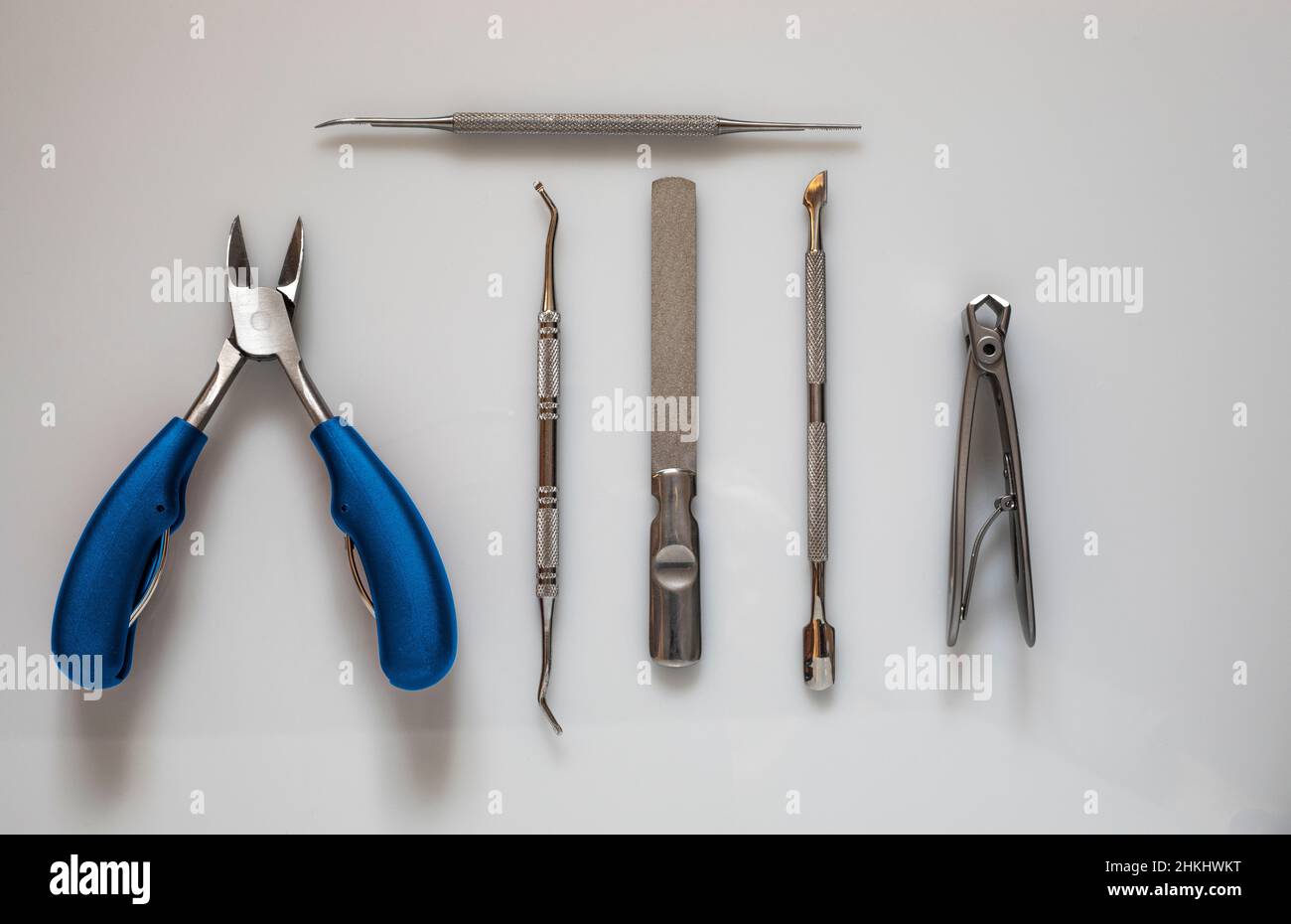 podiatry utensils on a bright white background clippers with blue ...