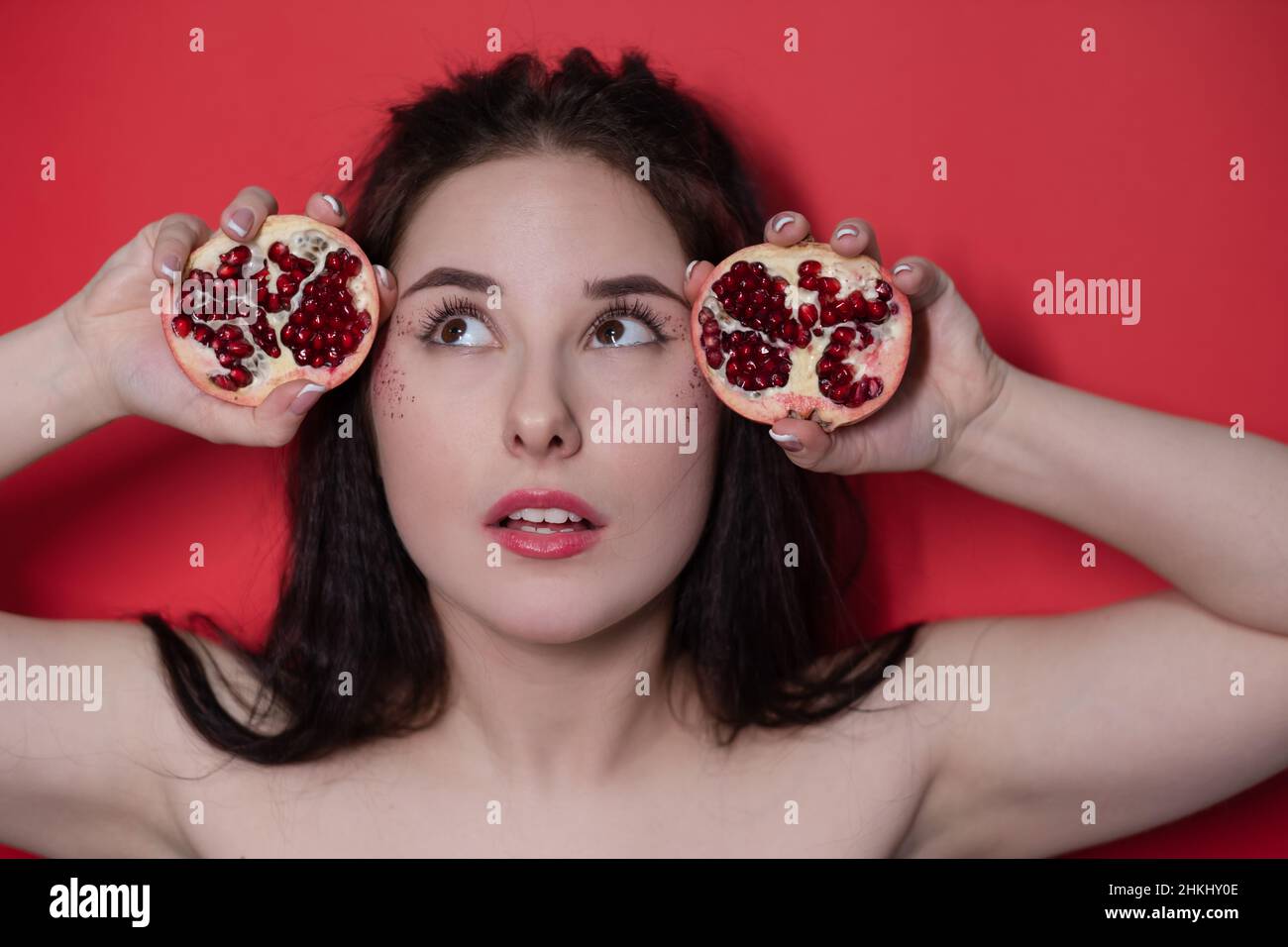 charming brunette woman girl female with cropped half pomegranate near ...