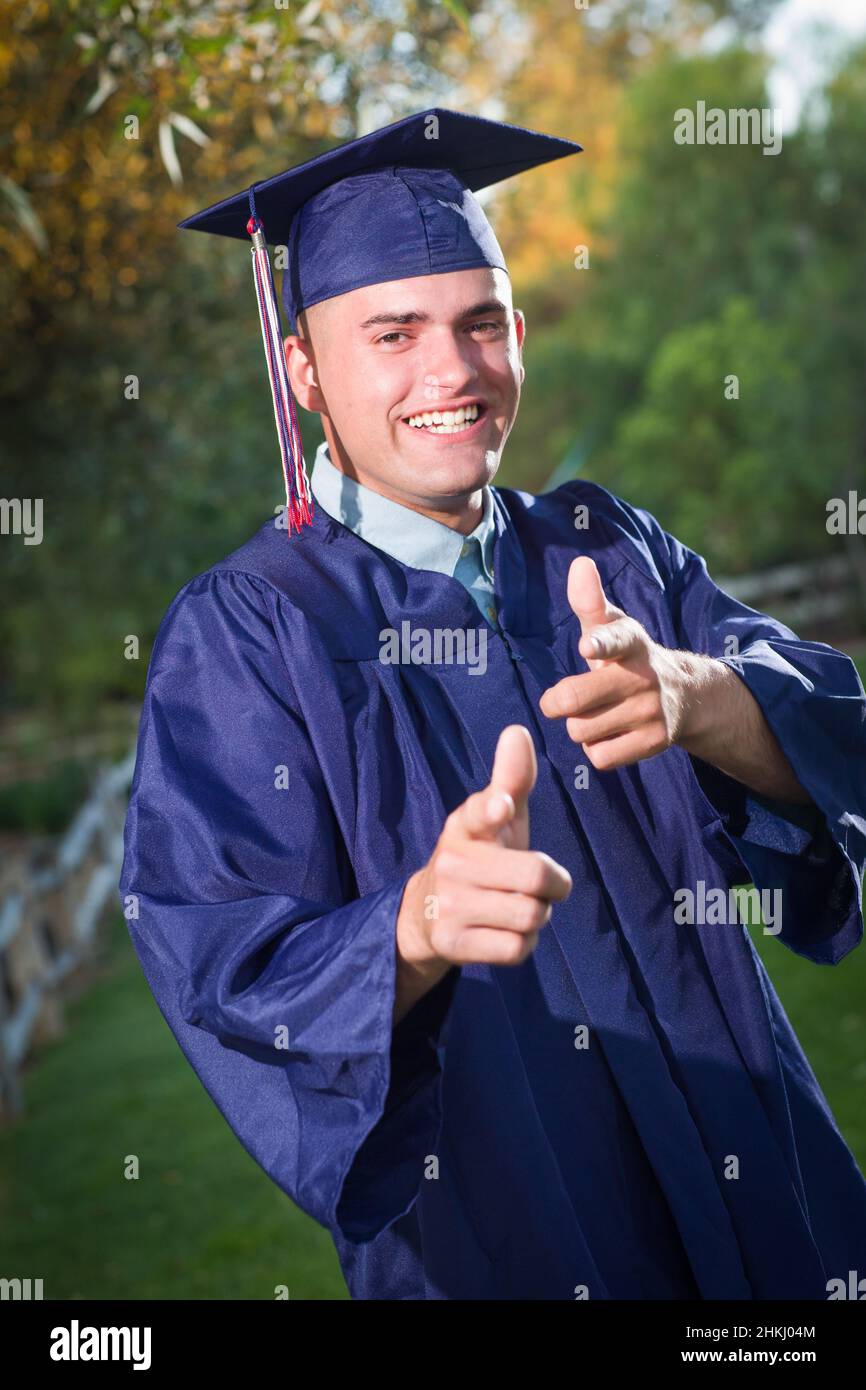 Happy Handsome Male Graduate in Cap and Gown Outside Stock Photo - Alamy