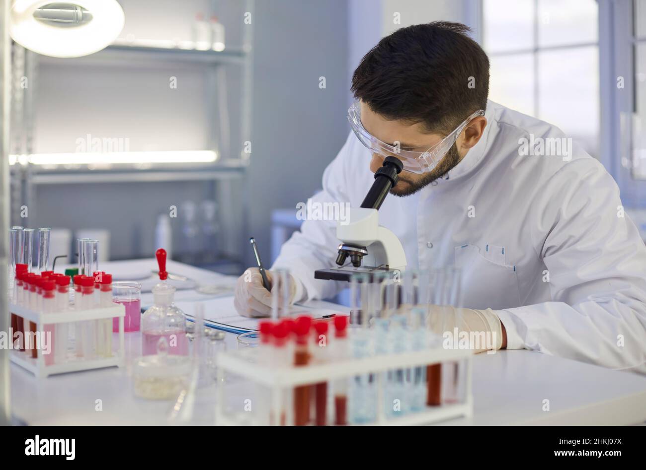 Male lab assistant make experiments in laboratory Stock Photo - Alamy