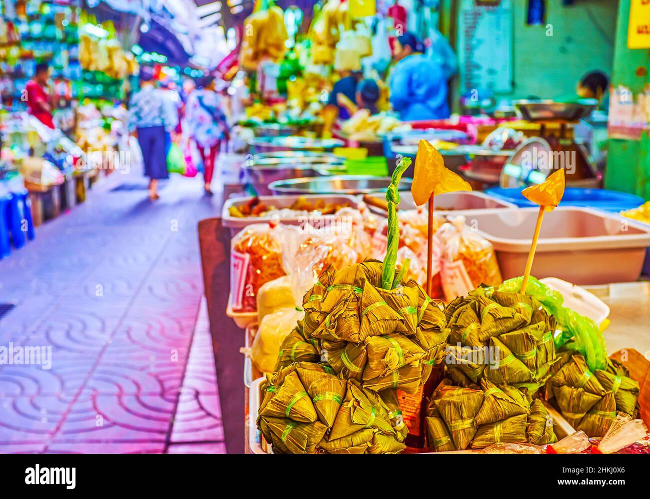 The showcase with the heaps of thai food wrapped in banana leaves ...